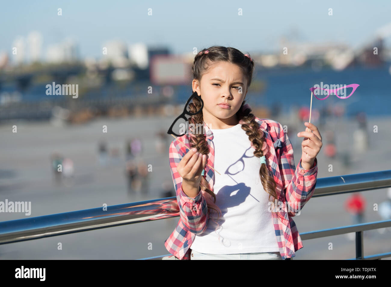 Which props to choose. Doubting small girl choosing glasses props ...