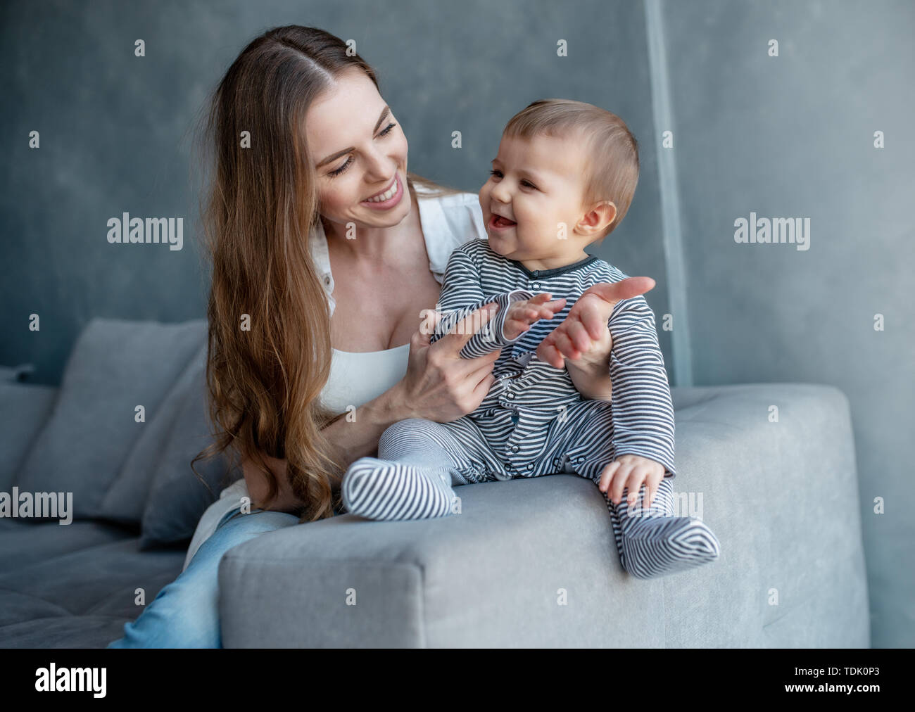 Little child smiling and happy with mom Stock Photo - Alamy