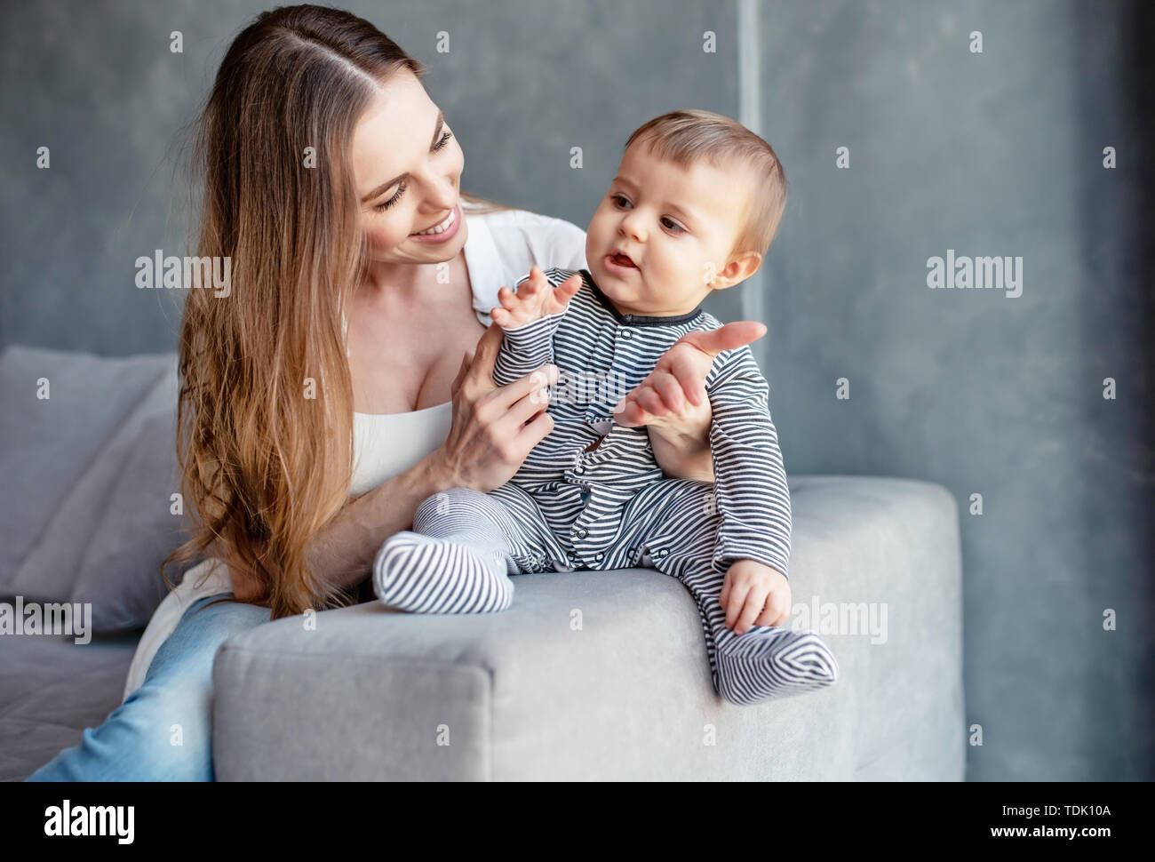 Little child smiling and happy with mom Stock Photo - Alamy