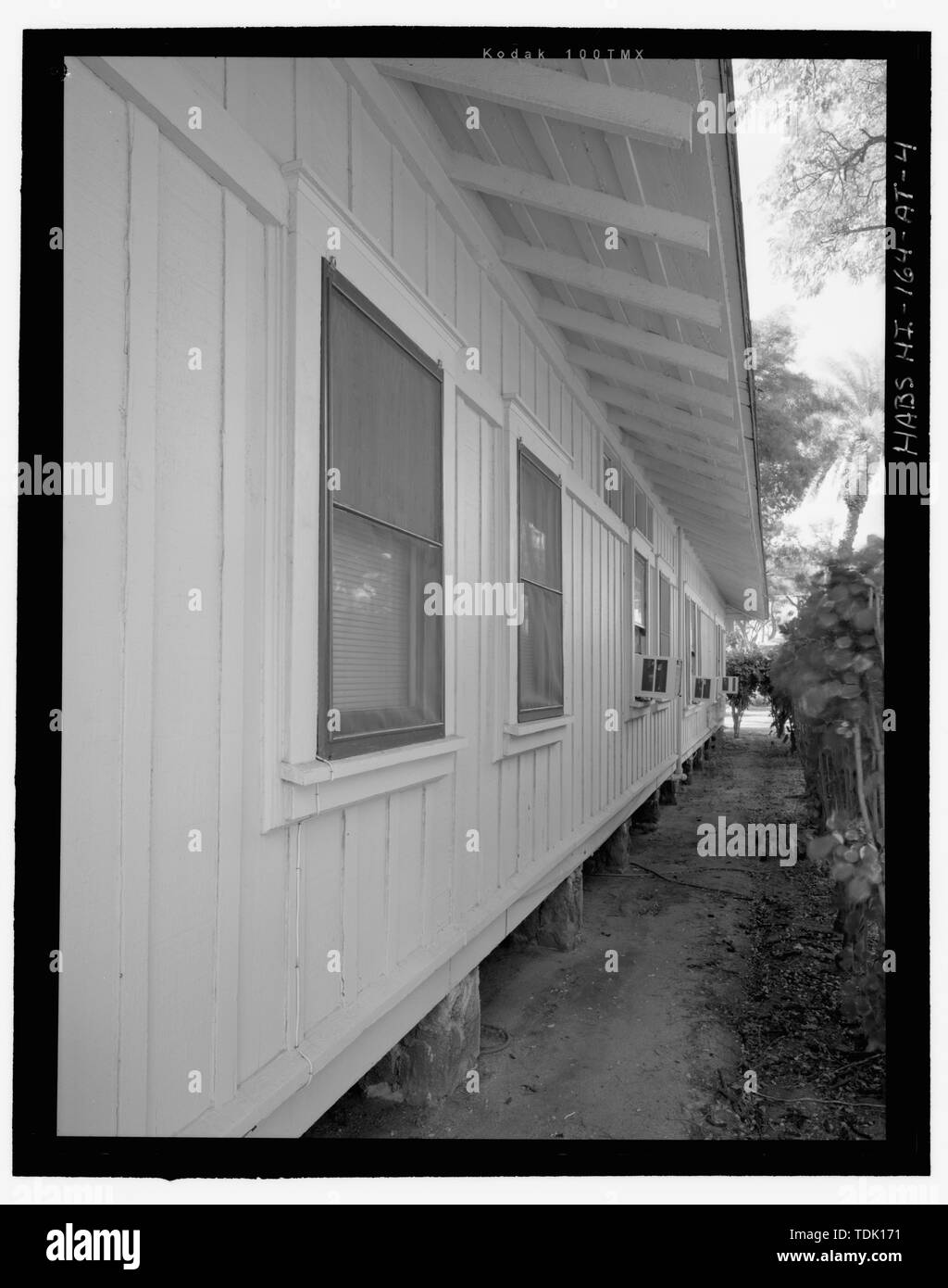 OBLIQUE VIEW OF THE NORTHWEST SIDE. NOTE THE LAVA ROCK FOUNDATION PIERS AND DETAILING AT THE ...