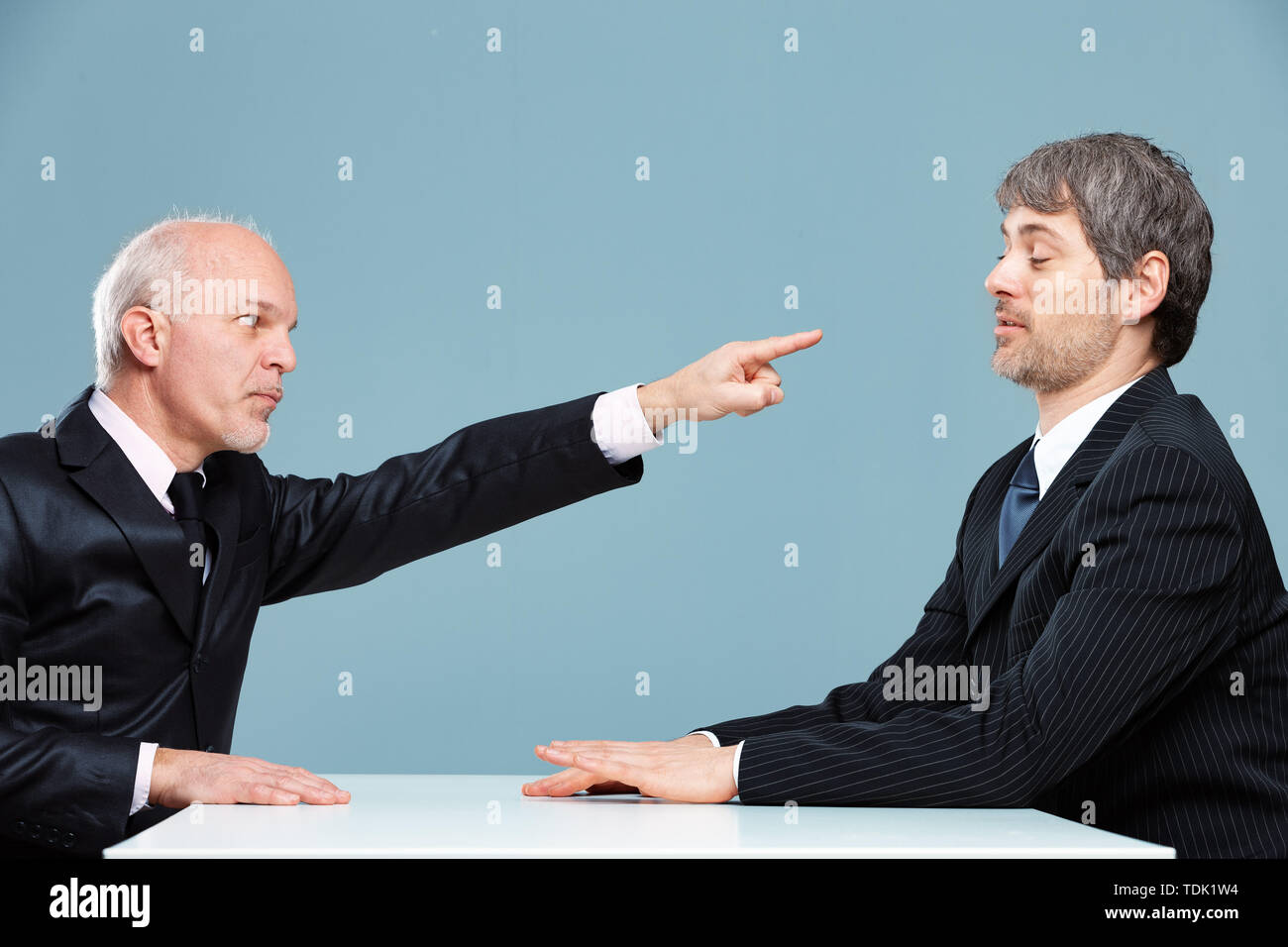 Two businessmen having an argument in the office with the more dominant ...