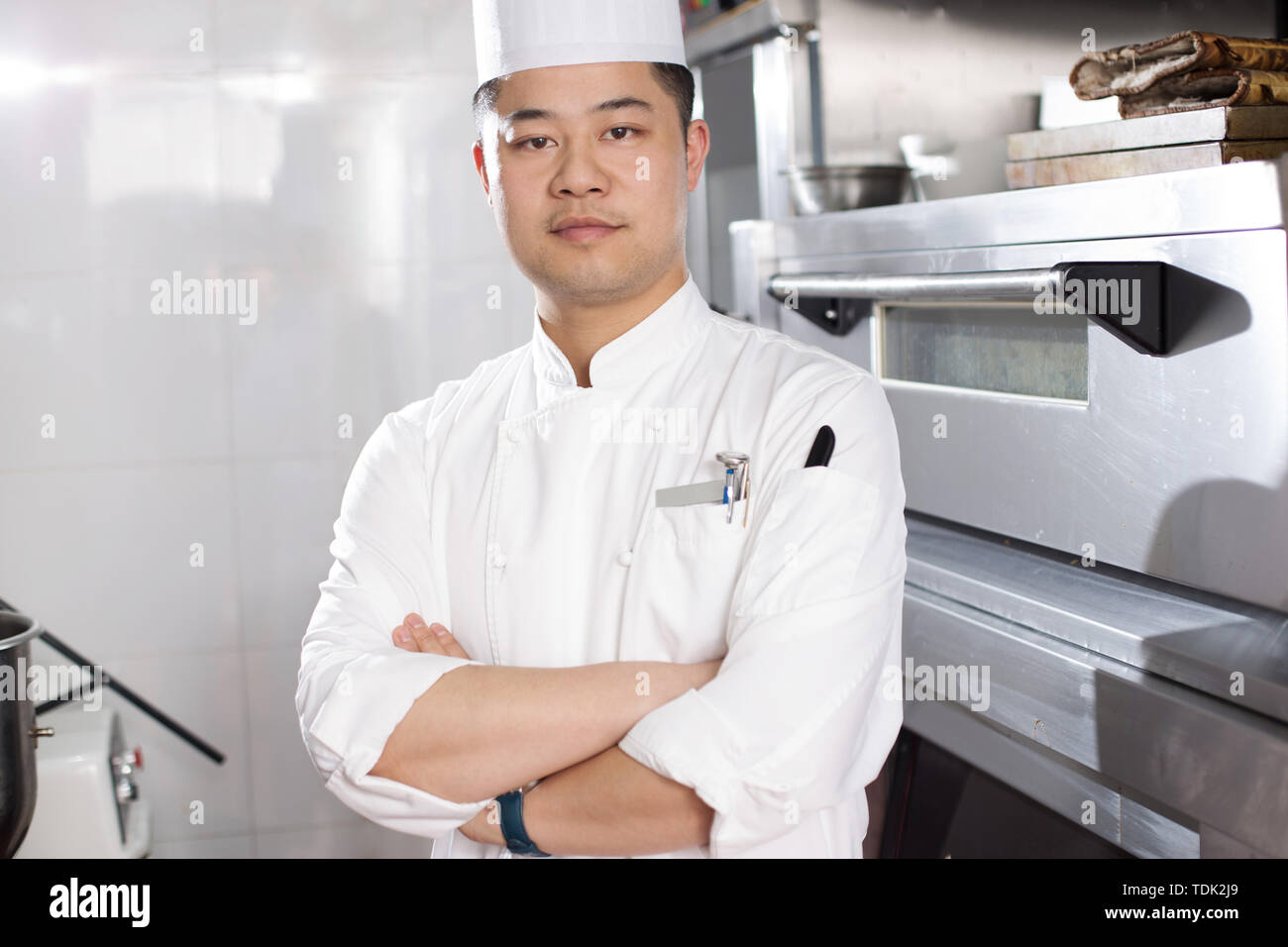 young chinese man chelf in modern kitchen Stock Photo - Alamy