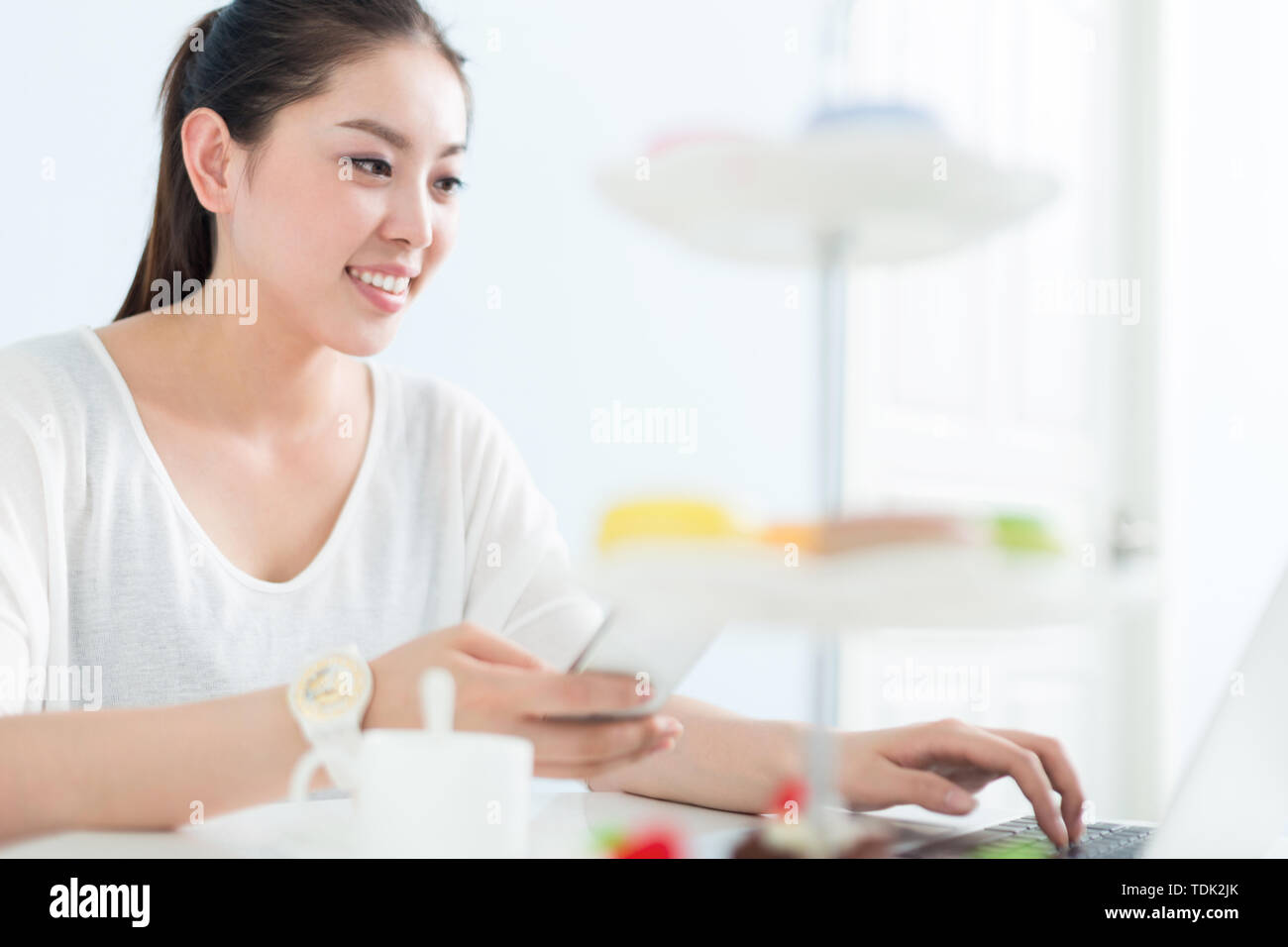 young pretty chinese woman working with laptop in office Stock Photo ...