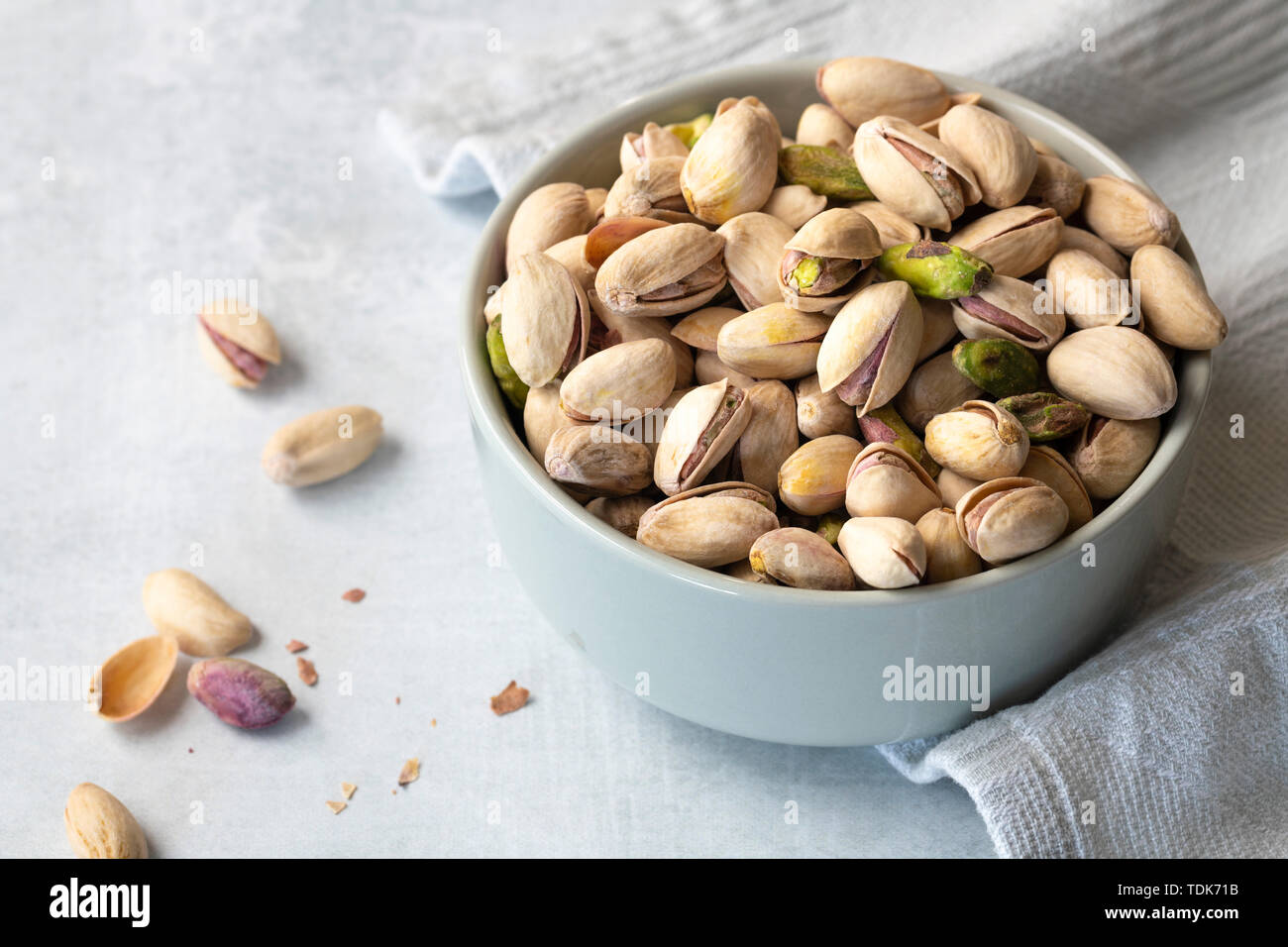 Roasted pistachio nuts in a bowl Stock Photo - Alamy