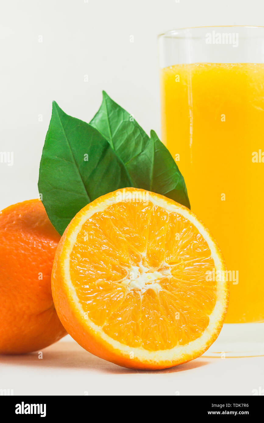 Cut orange with orange juice Stock Photo - Alamy