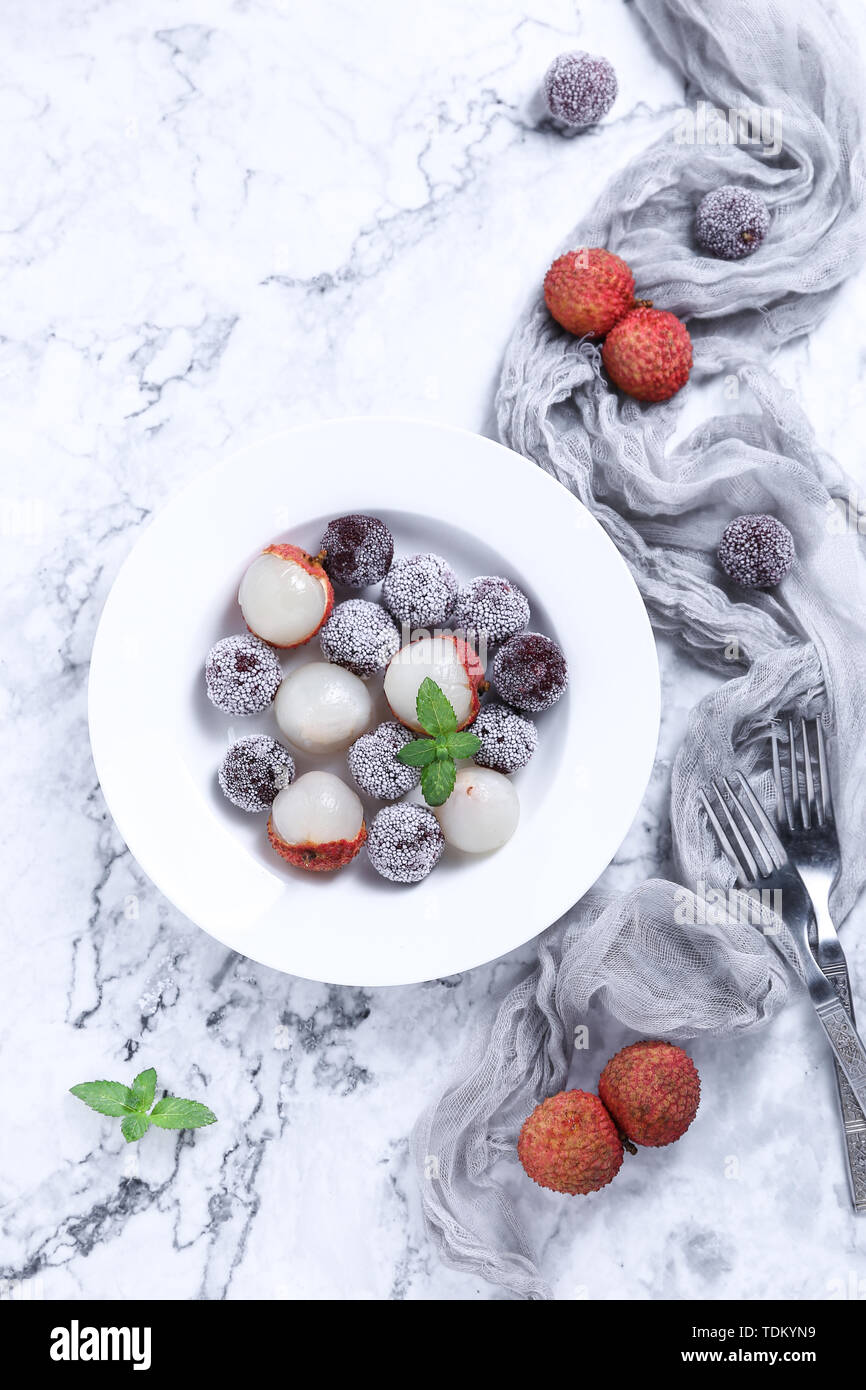Frozen plum and fresh lychee Stock Photo - Alamy