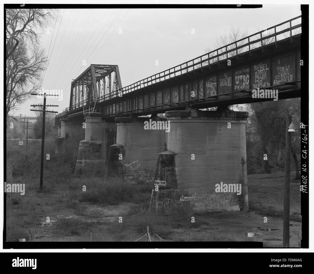 Oblique view to south-southwest of upstream (east) side of bridge from ...