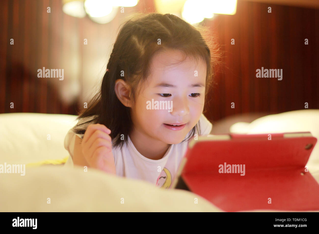 Little girl playing tablet Stock Photo - Alamy