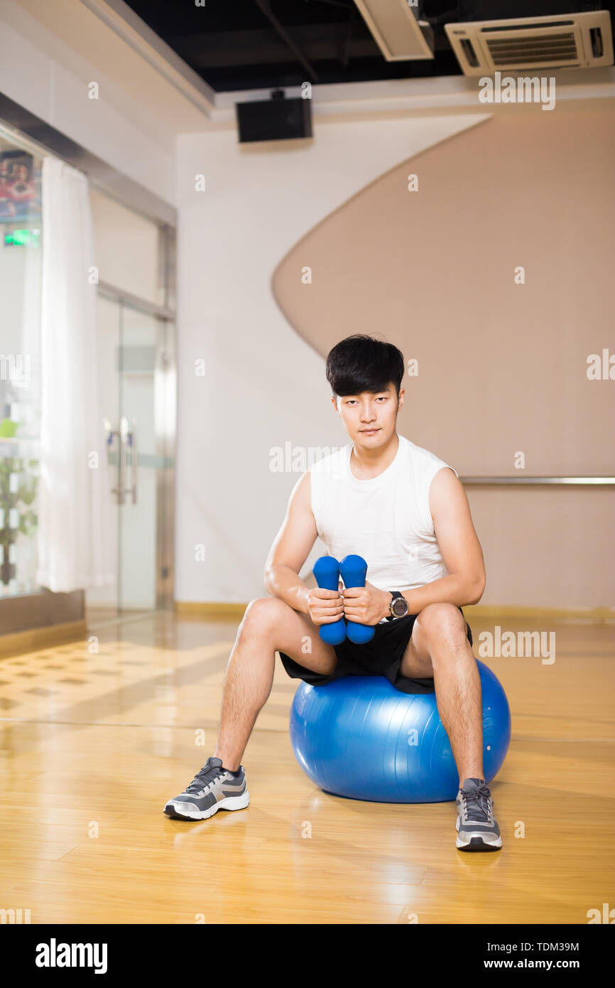 young handsome asian man works out in modern gym Stock Photo - Alamy