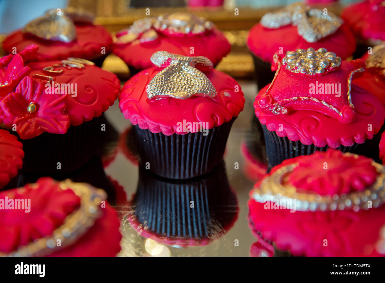 Red and golden cake. Feather cake. Cake with pearl beads on top Stock ...