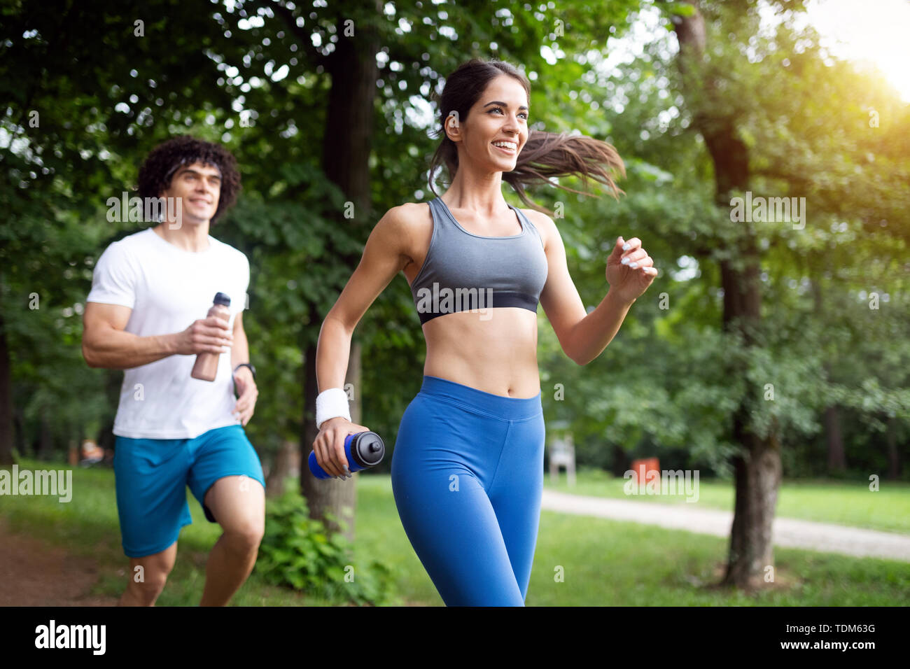 Happy couple running and jogging together outdoor Stock Photo - Alamy