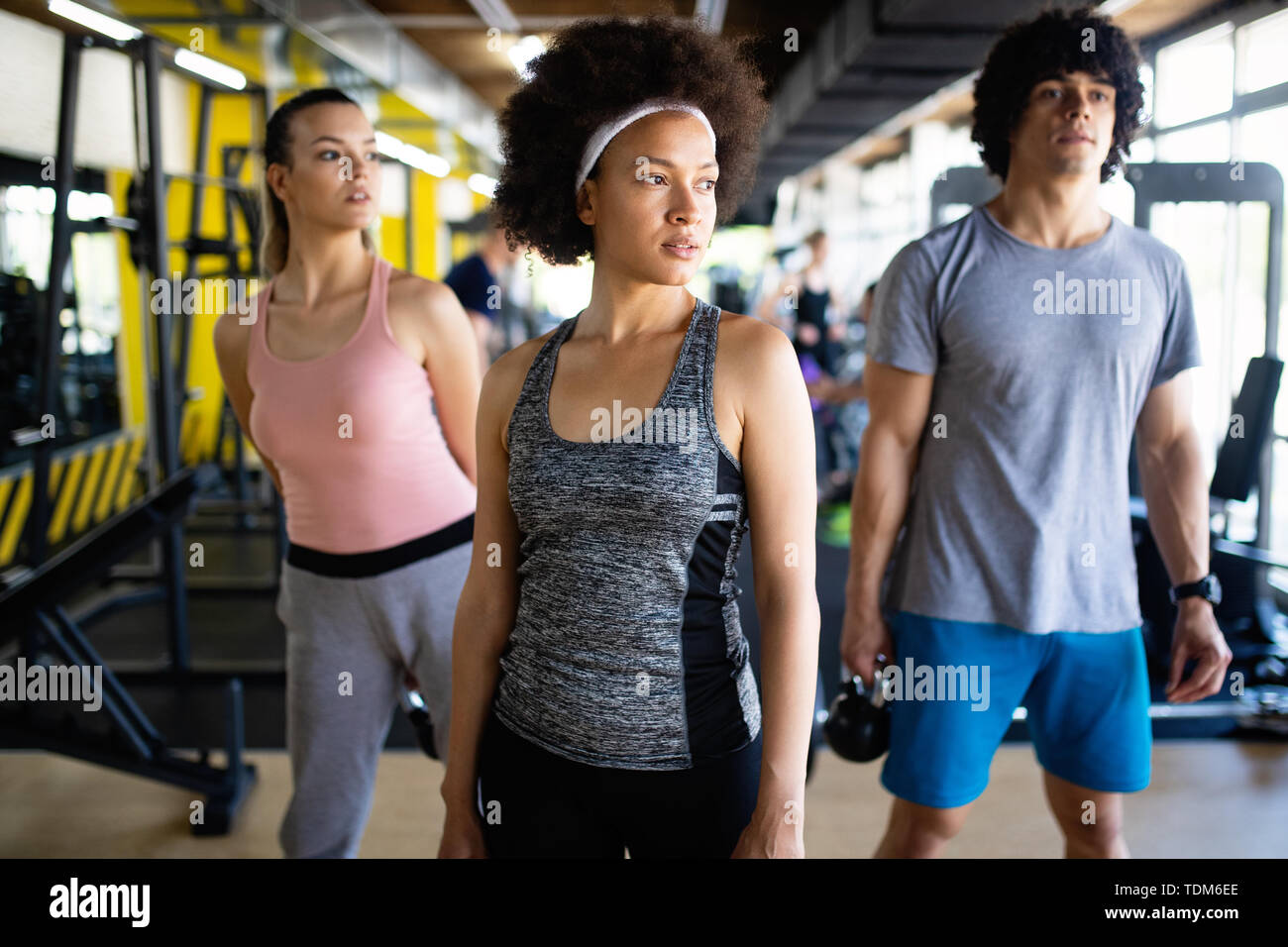 Group of young people training in gym Stock Photo - Alamy