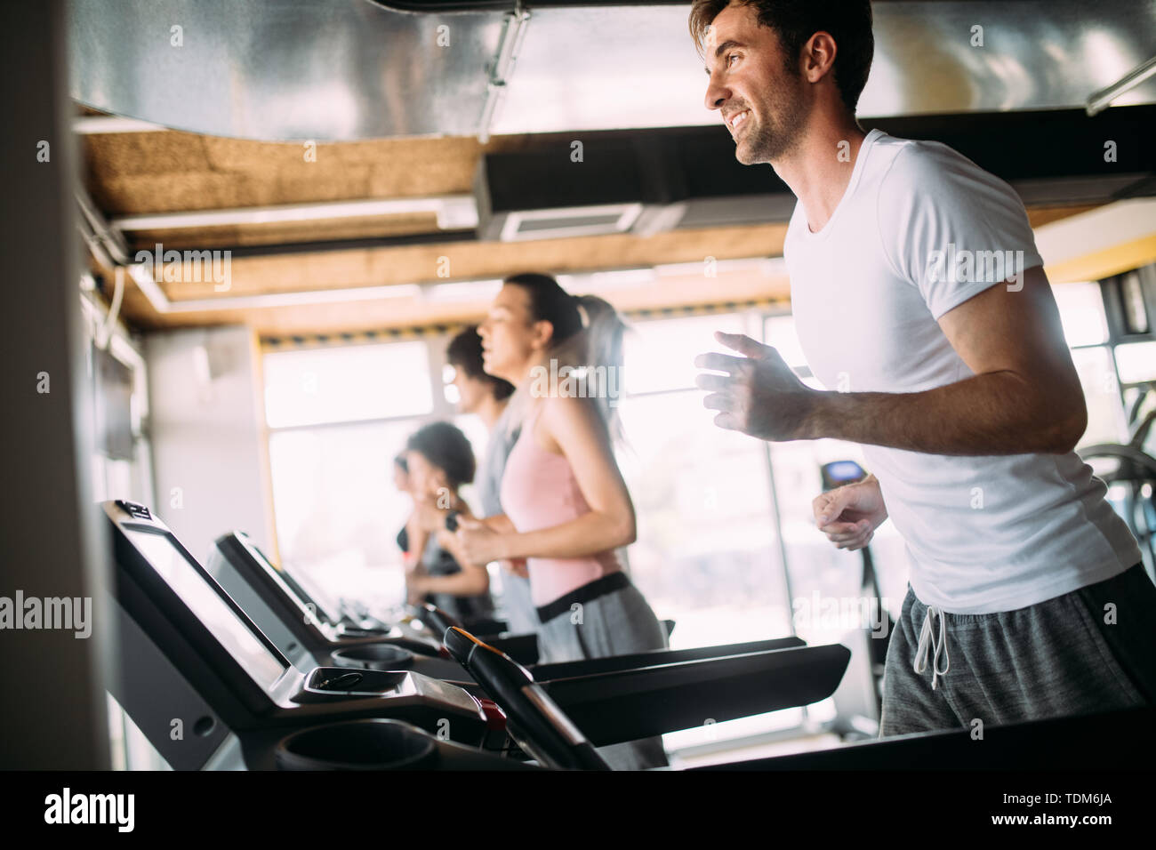 Group of healthy fit people at the gym exercising Stock Photo - Alamy