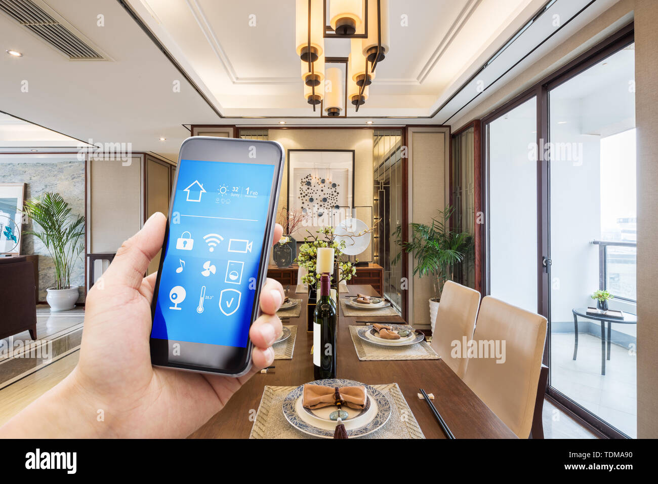smart phone with smart home with modern dining room Stock Photo - Alamy