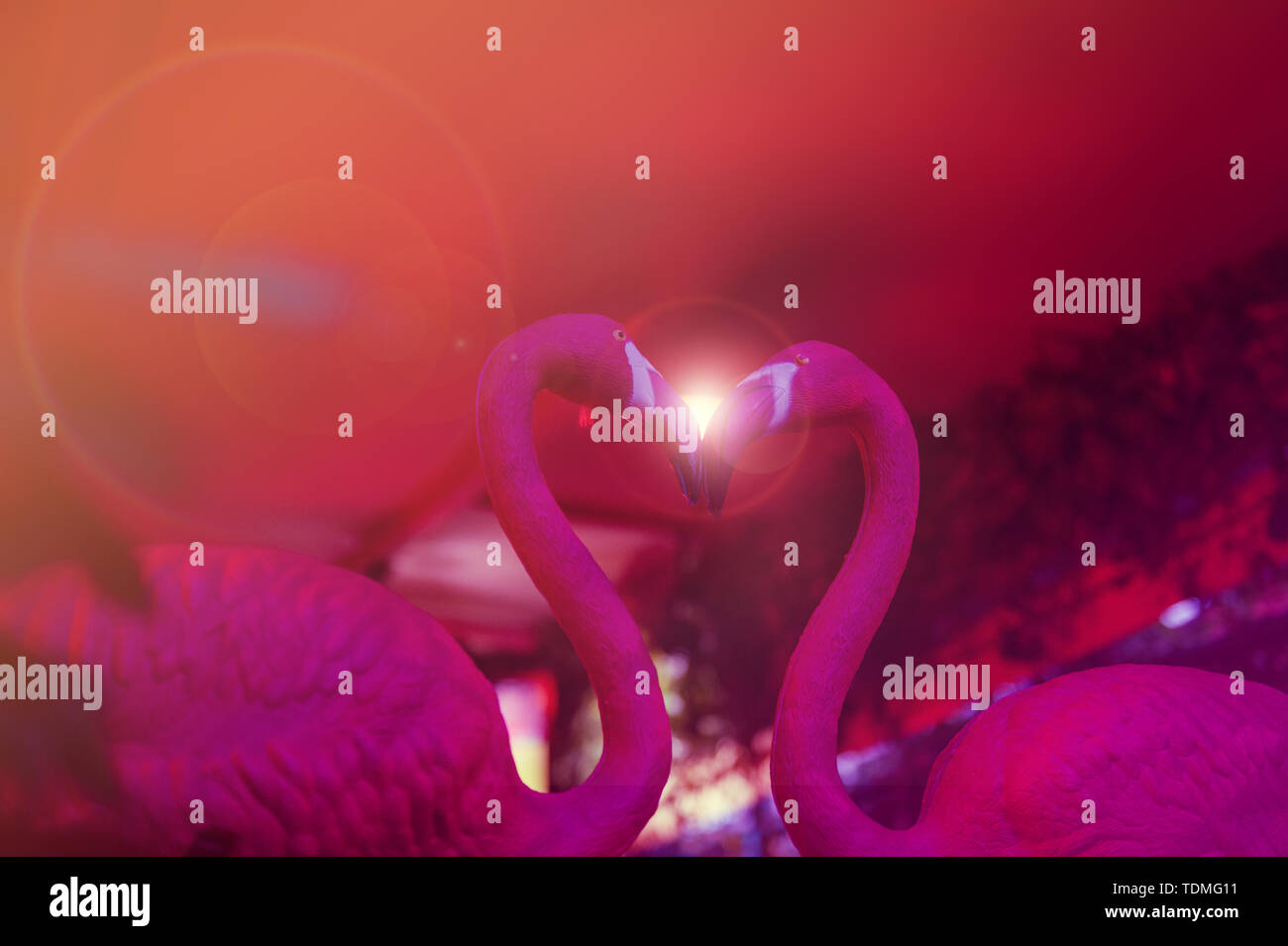 A pink flamingo ceramic facing each other to form a heart shape Stock ...