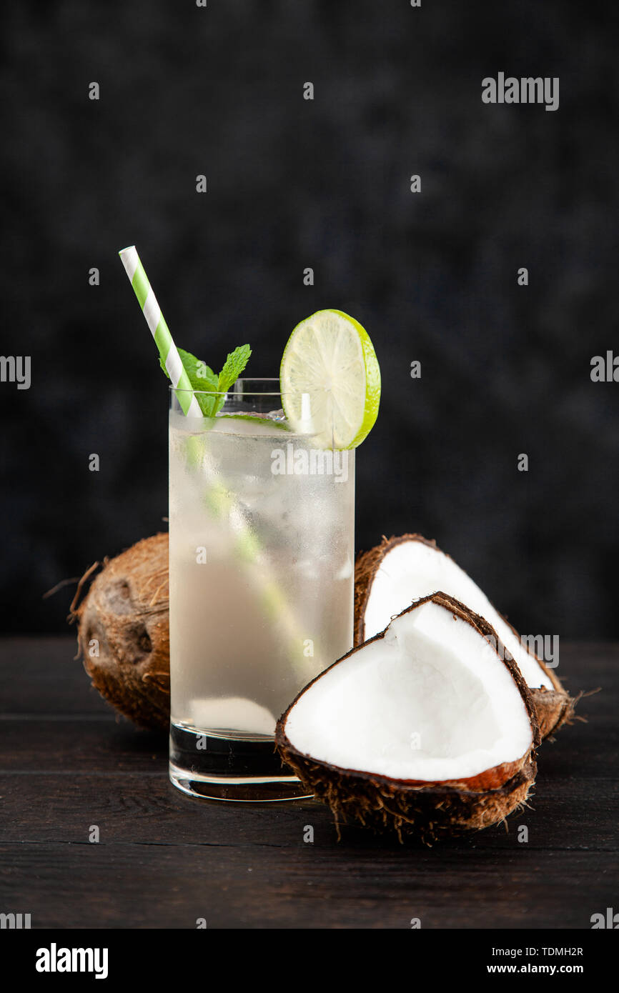 Coconut water drink on dark background Stock Photo - Alamy