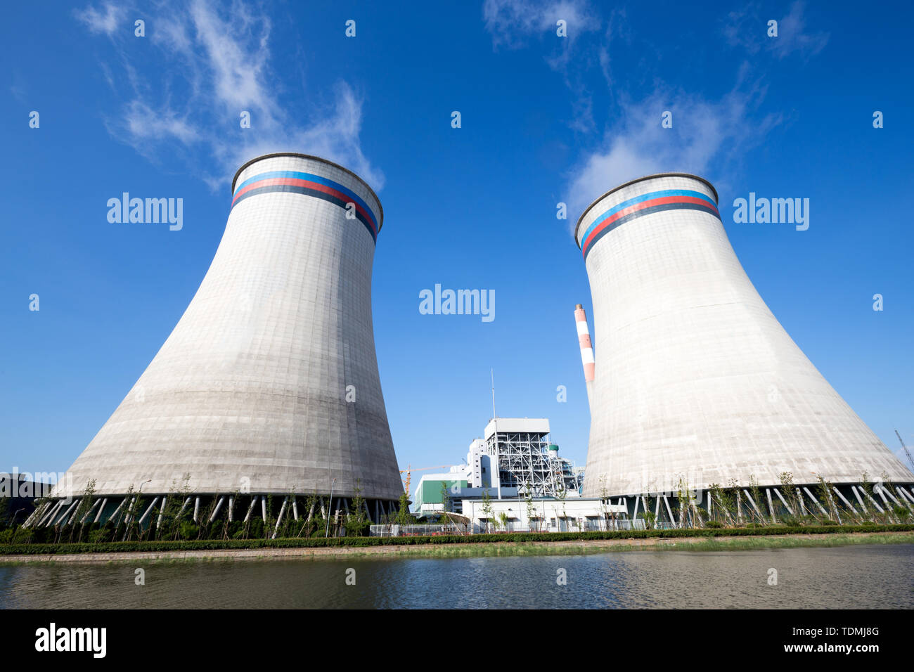 modern power plant near river in blue sky Stock Photo - Alamy