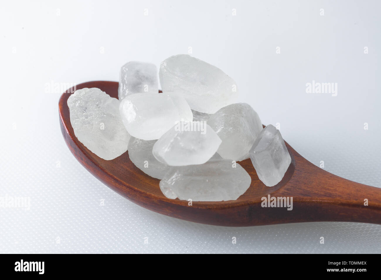 A spoonful of ice sugar placed on a white background Stock Photo - Alamy
