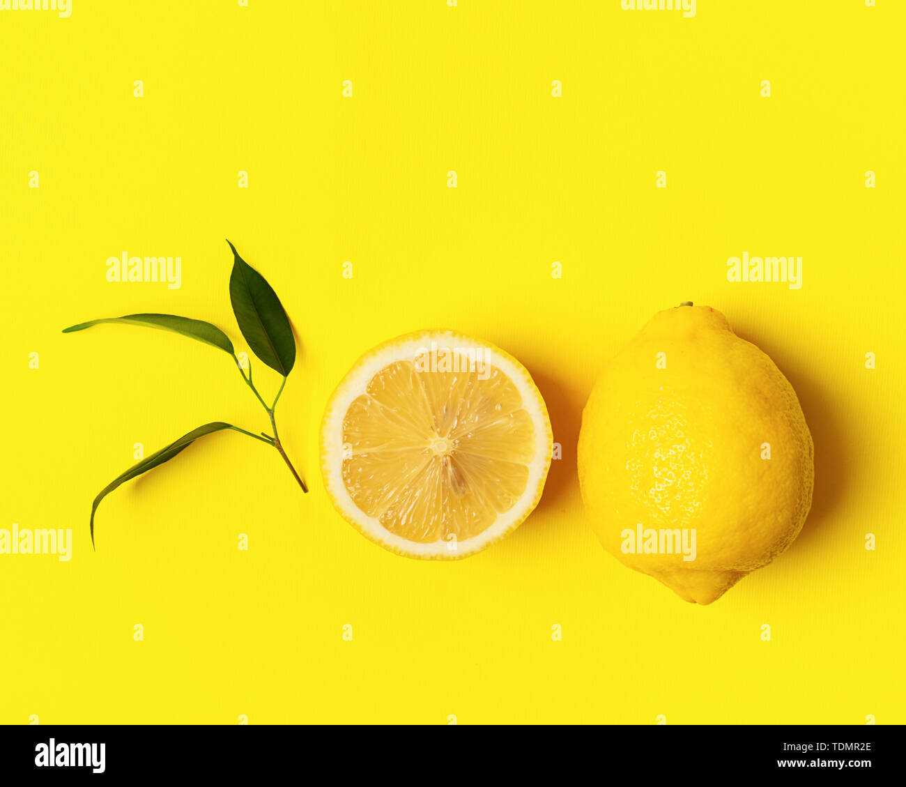Fresh juicy lemon on a bright yellow background. Concept minimalism ...