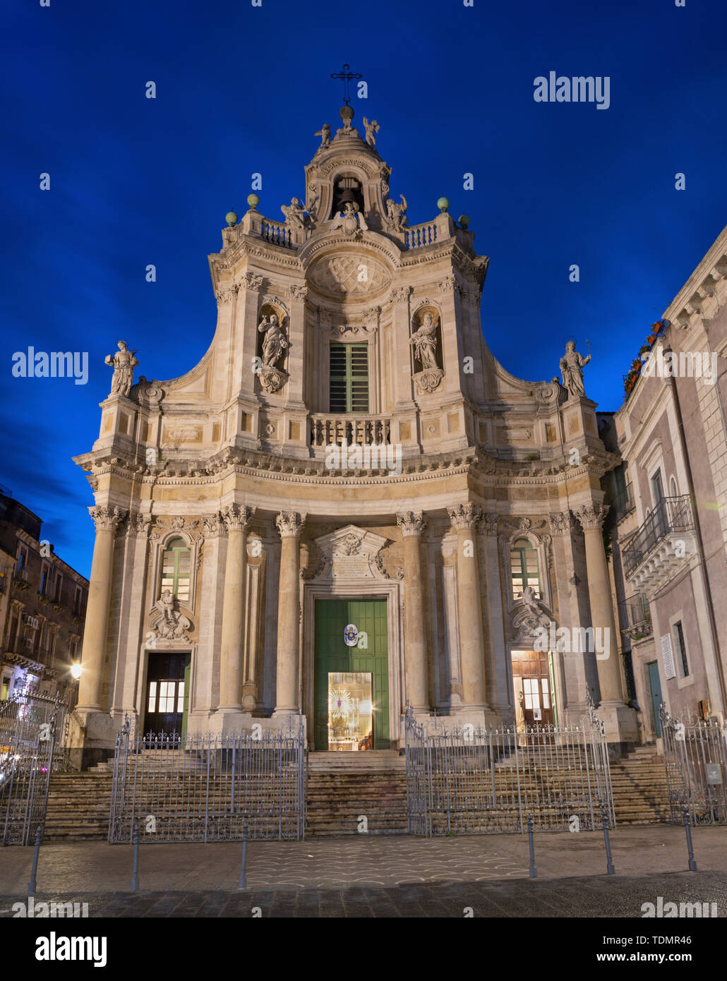 Catania - The baroque facade of church Basilica Collegiata at dusk ...
