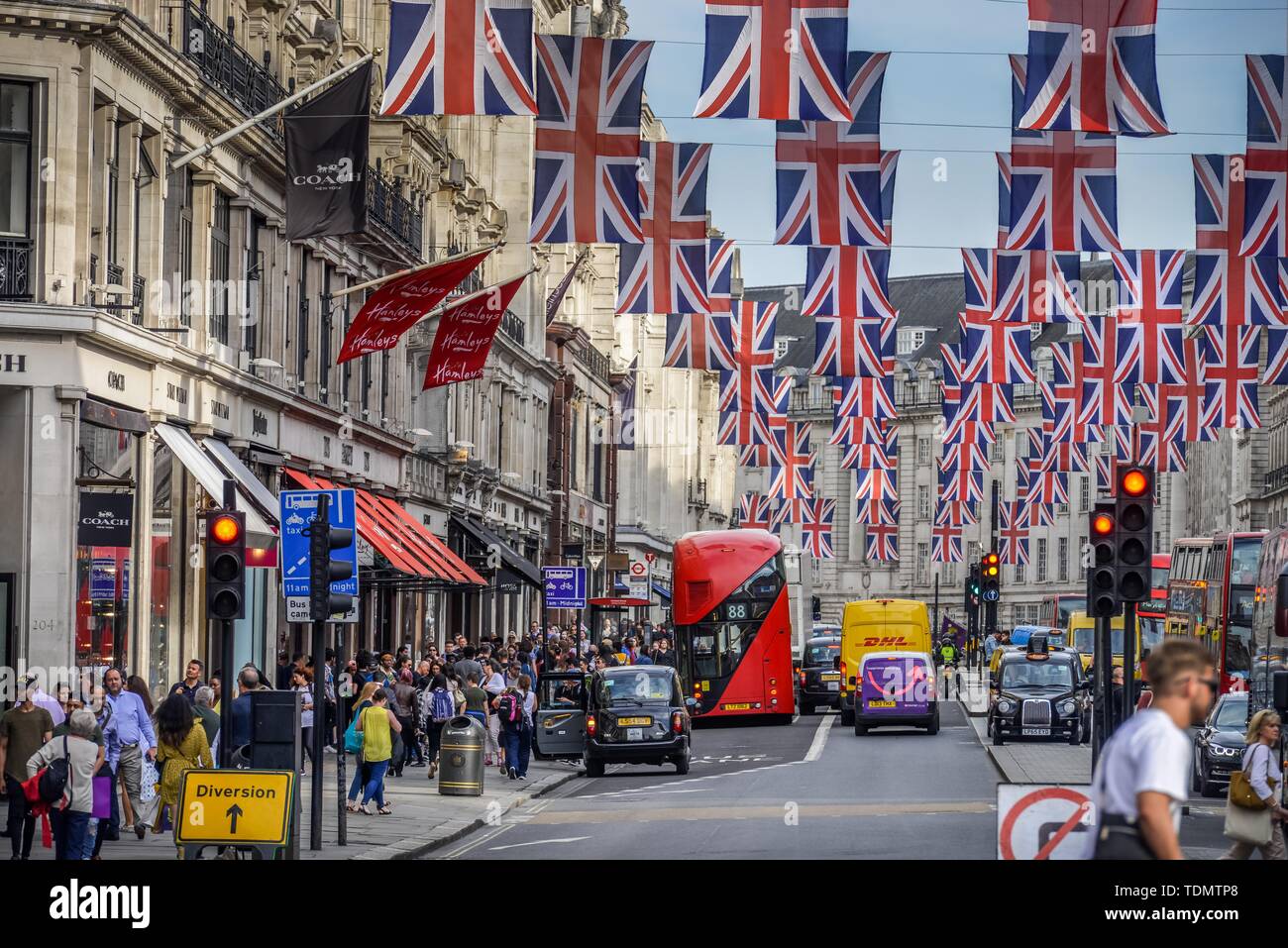 Busy street with many British flags, street scene, Regent St, London ...