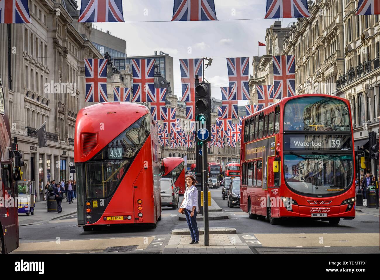 Double decker buses in street with many british flags hi-res stock ...