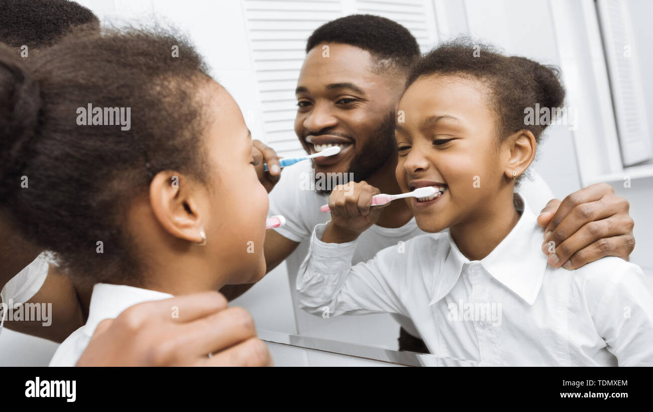 Little Daughter And Father Brushing Teeth Together Stock Photo - Alamy