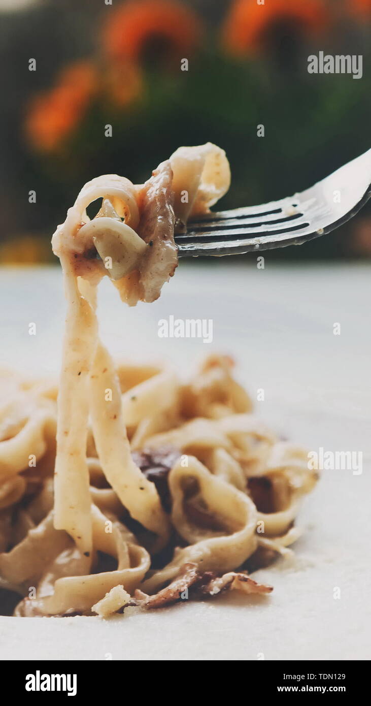 Eating traditional italian pasta in restaurant outdoor Stock Photo - Alamy