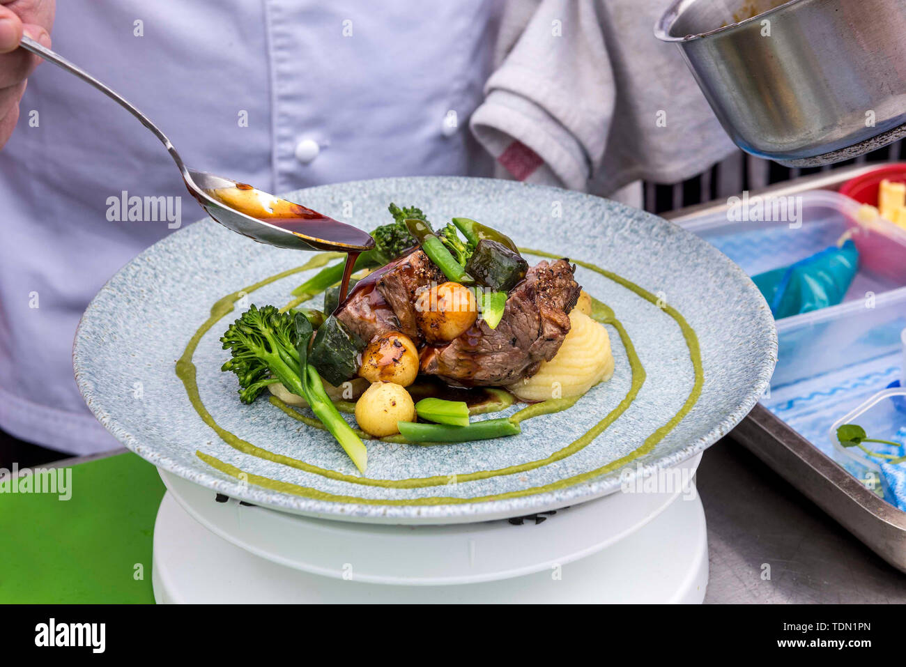Roast dinner served on a plate to include vegetables, beef, and gravy ...