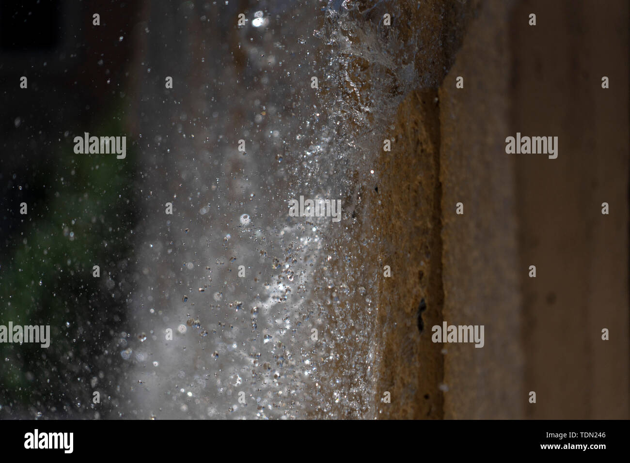 fountain splash on a wall detail close up Stock Photo - Alamy