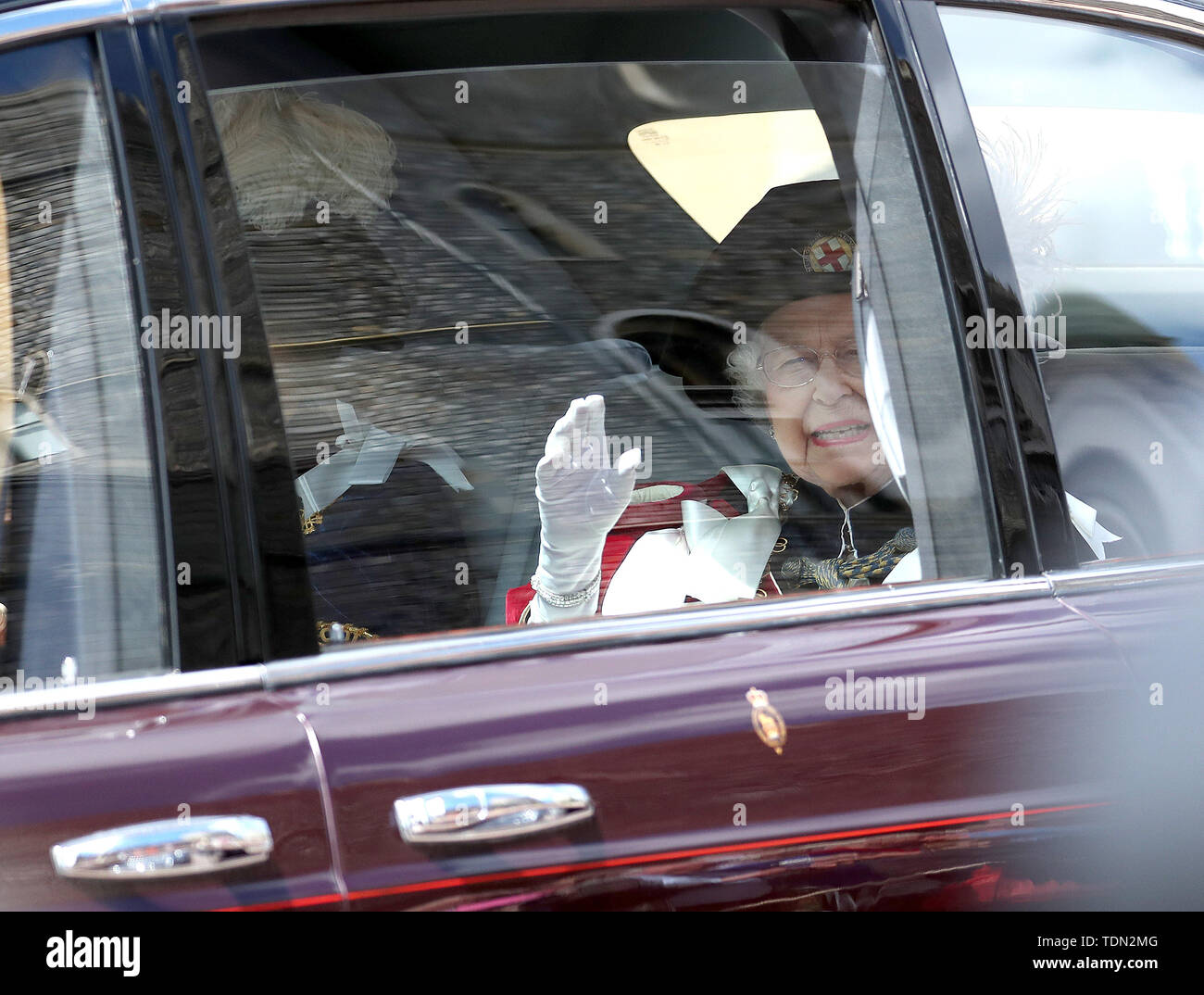 Queen Elizabeth II waves as she arrives for the annual Order of the ...