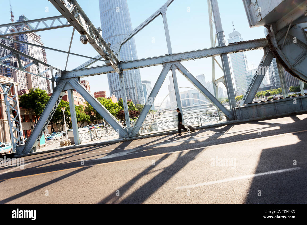 Traffic on steel bridge interior and skyline at sunset Stock Photo - Alamy