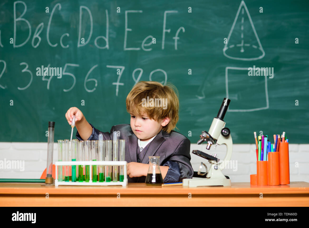 Kid study chemistry school lesson. School education. Boy use microscope ...