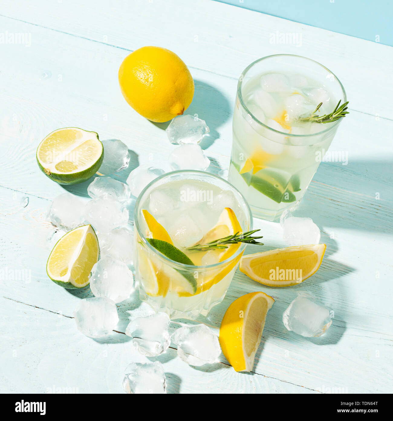 A drink of lemon and lime lemonade in transparent glasses a blue ...