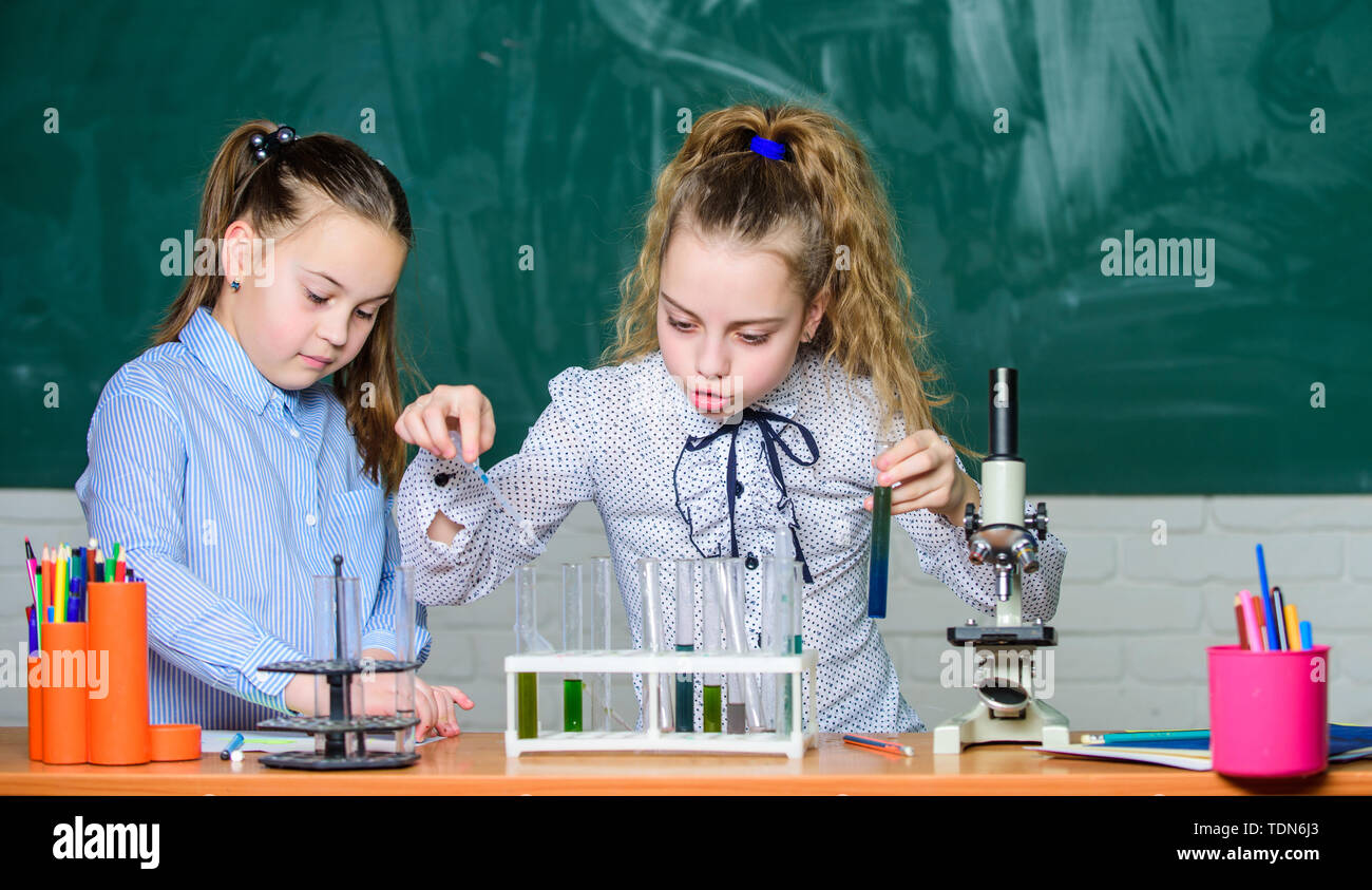 Really busy. students doing biology experiments with microscope. Little ...