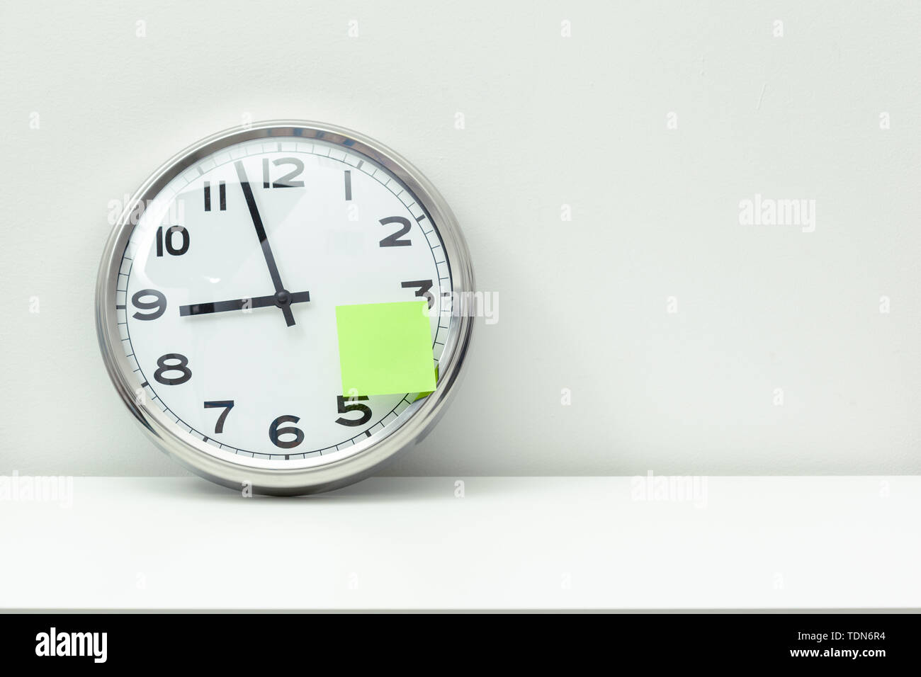 Clock at an office table Stock Photo - Alamy