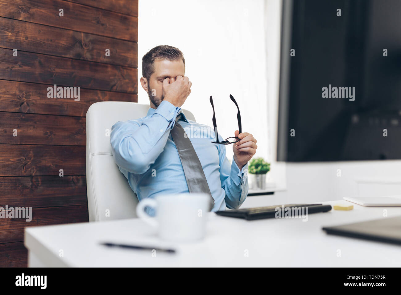 Tired businessman from heavy workload sitting at the desk Stock Photo ...