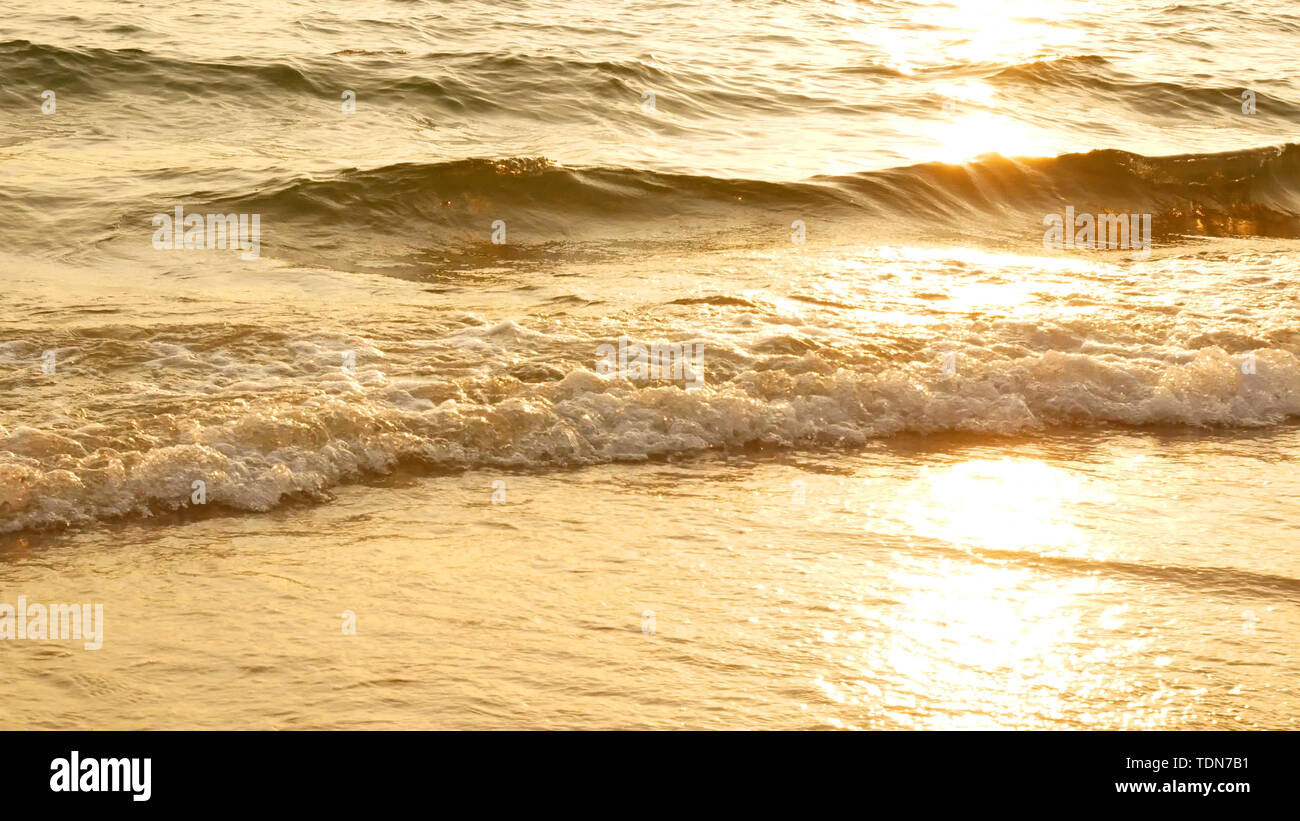 amazing sunset over the tropical beach. ocean beach waves on beach at sunset time , sunlight ...