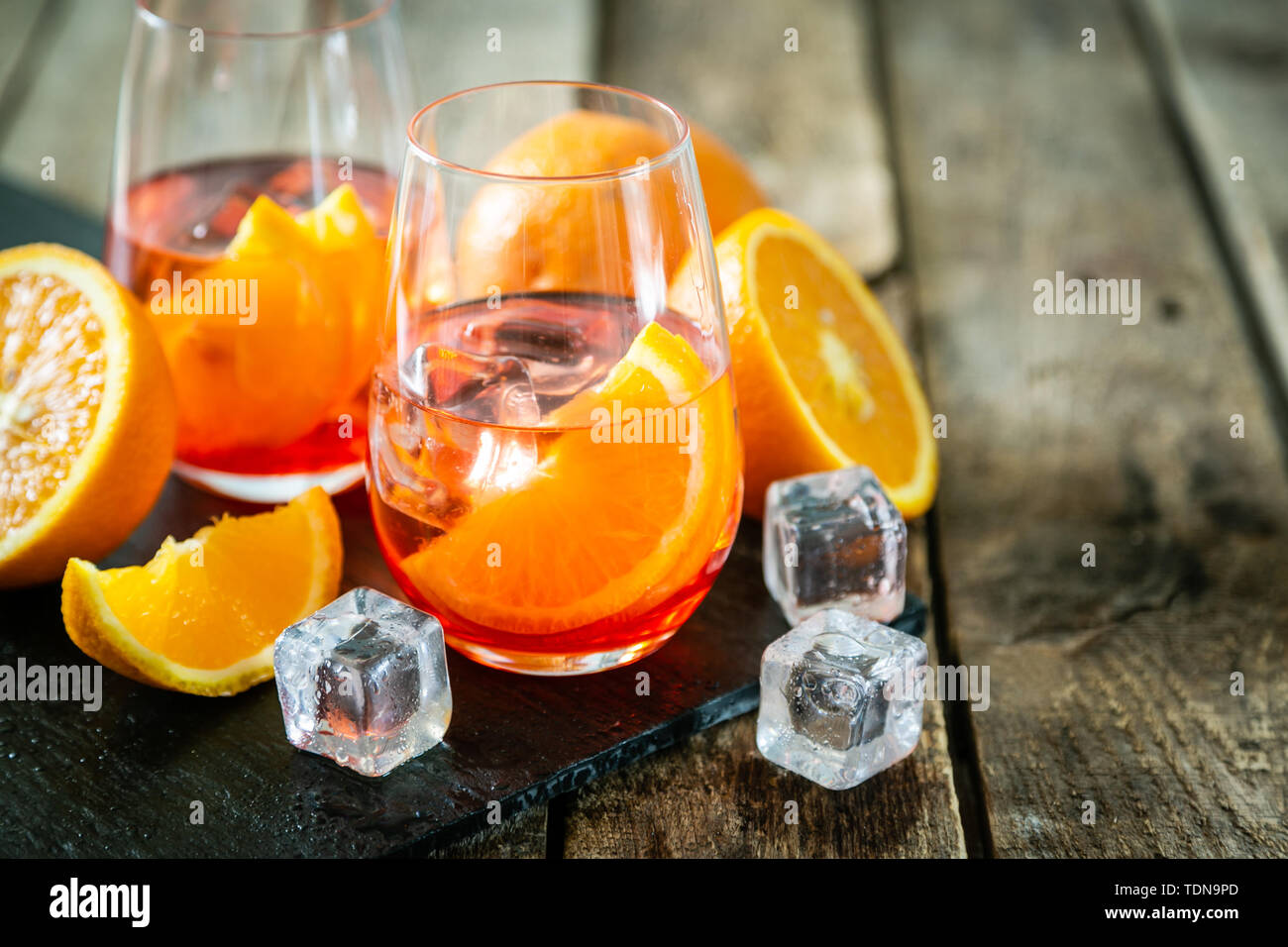 Aperol and ingredients drinks on wood background Stock Photo - Alamy