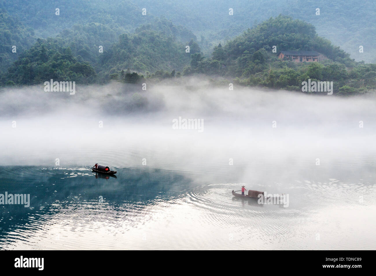 The fish beater in the morning fog lake Stock Photo - Alamy