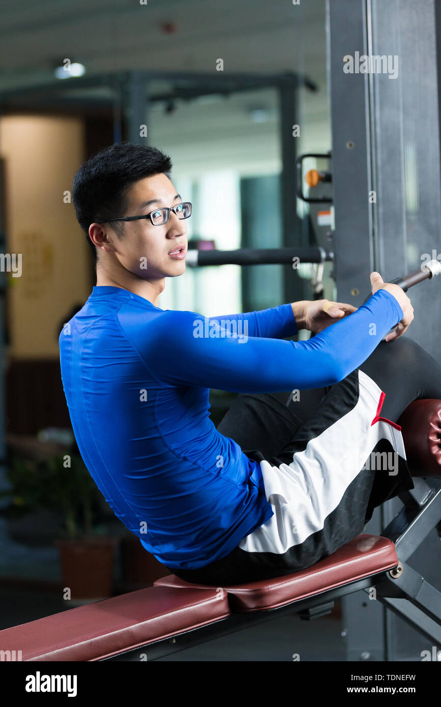 young asian man working out in modern gym Stock Photo - Alamy