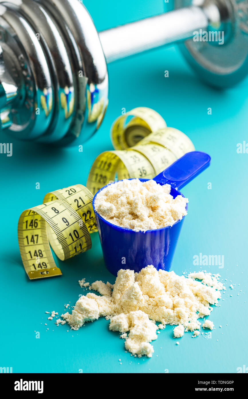 Whey protein powder in scoop and measuring tape Stock Photo - Alamy