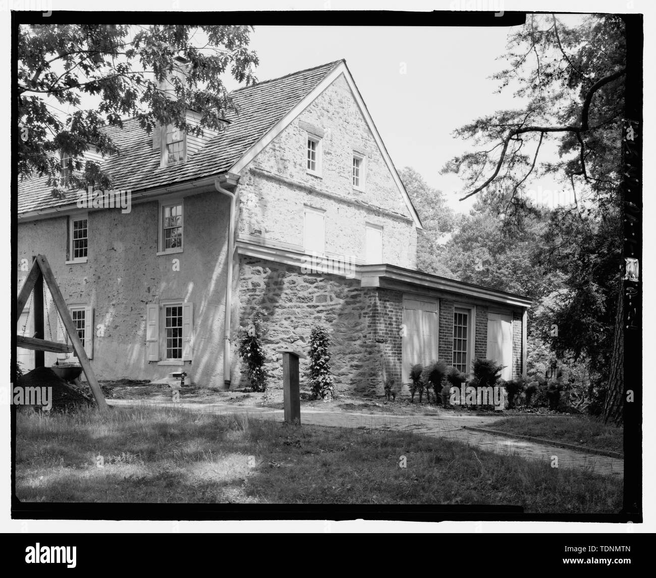 Perspective view from the southwest, focusing on the one-story ...
