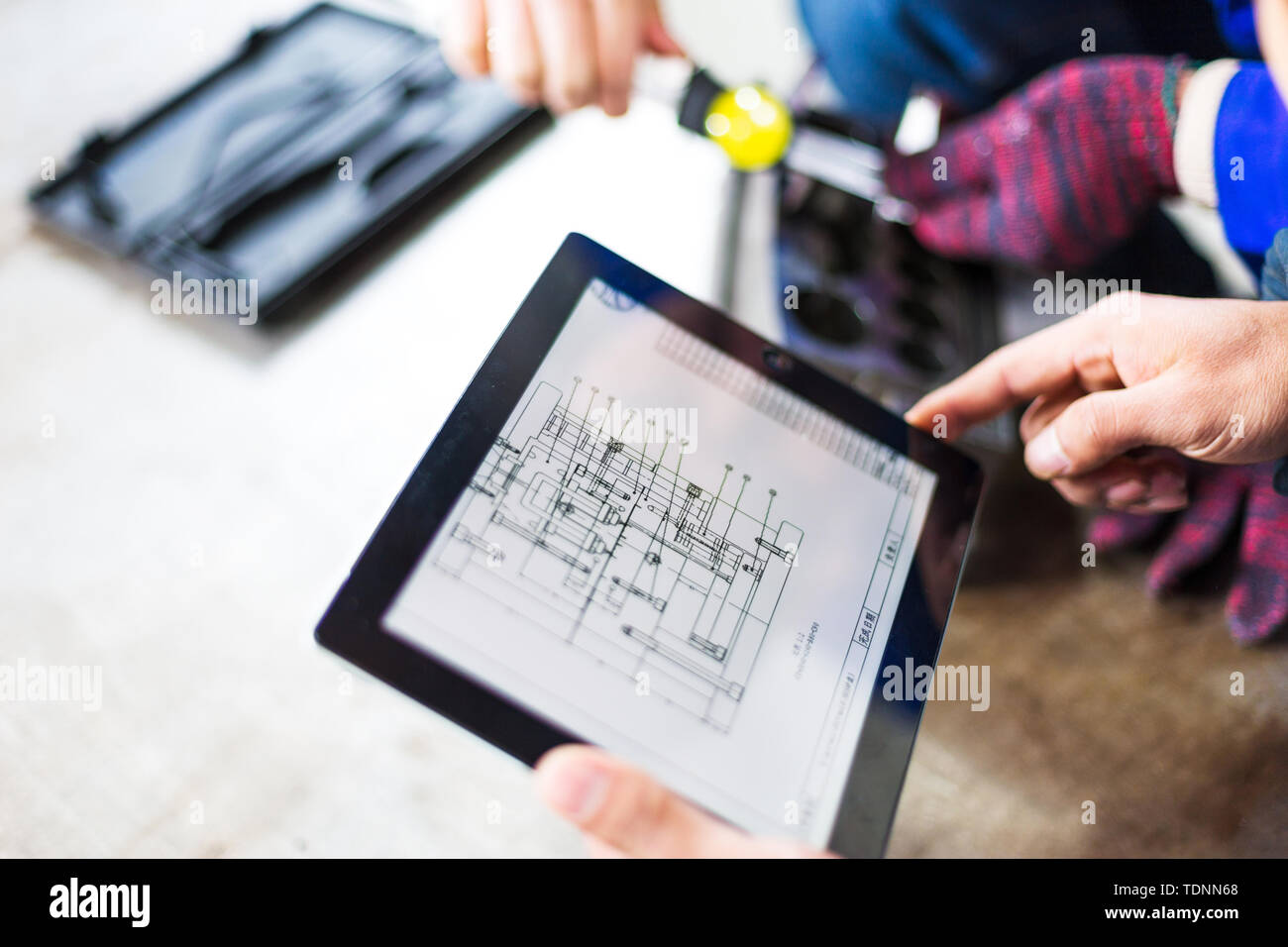 technician holds tablet with mechanical drawing Stock Photo - Alamy