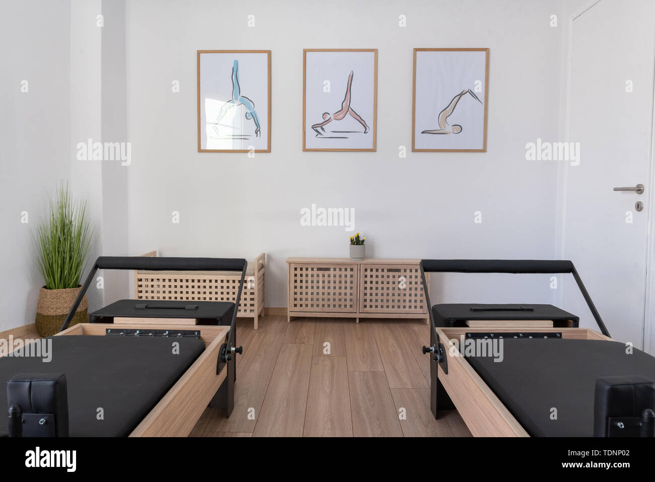 Pilates studio room with reformer beds Stock Photo - Alamy