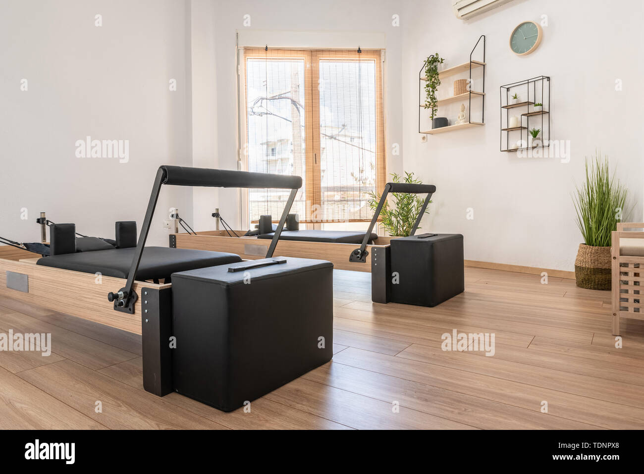 Pilates studio room with reformer beds Stock Photo - Alamy