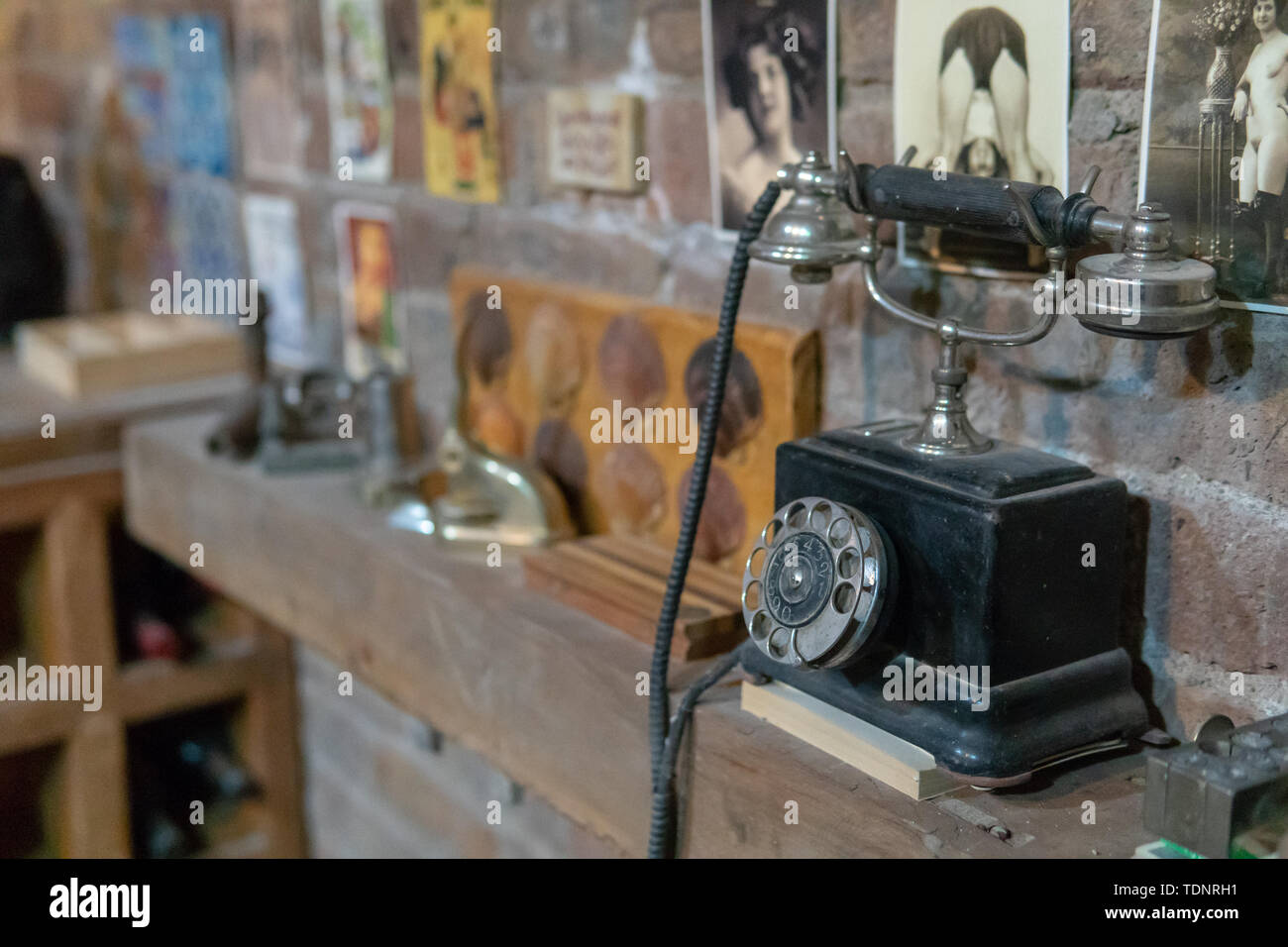A dusty black vintage telephone sites on an old shelf in the basement ...