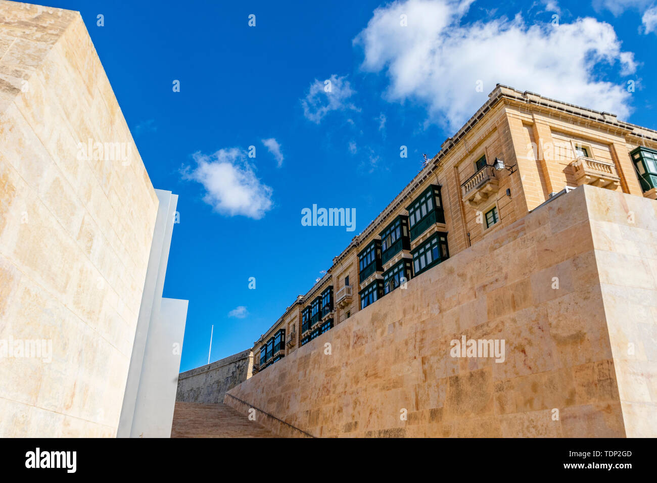 Typical narrow maltese streets with colorful traditional windows and ...