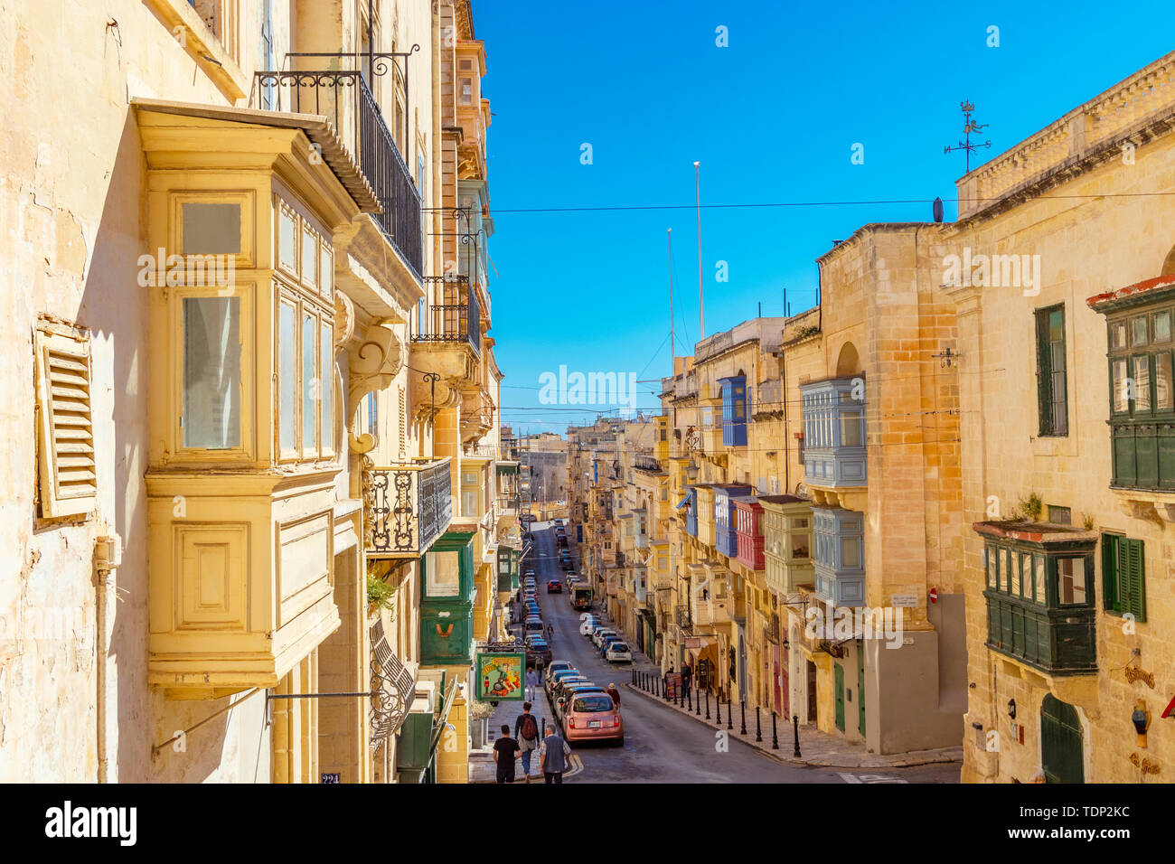 Typical narrow maltese streets with colorful traditional windows and ...