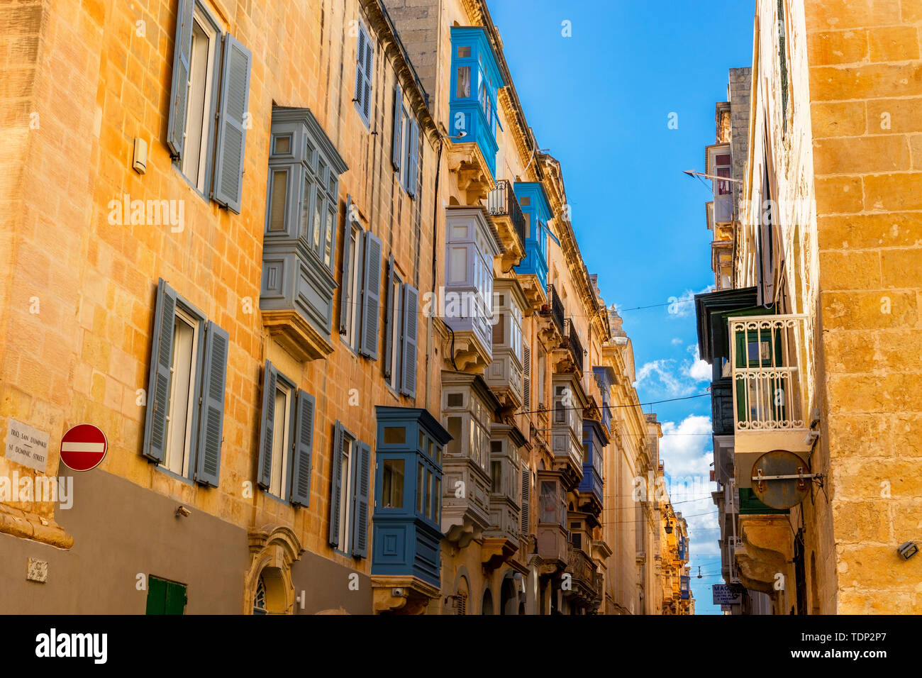 Typical narrow maltese streets with colorful traditional windows and ...